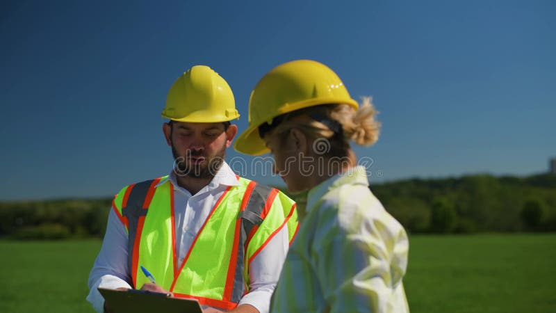 Two Employees of an Alternative Power Plant Talking about a Scheme of ...