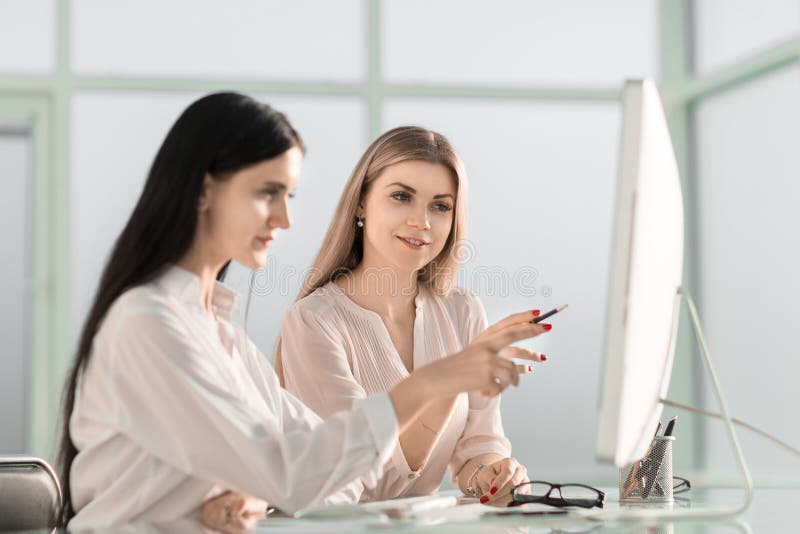 Two Employees are Discussing Something Sitting at the Office Table ...