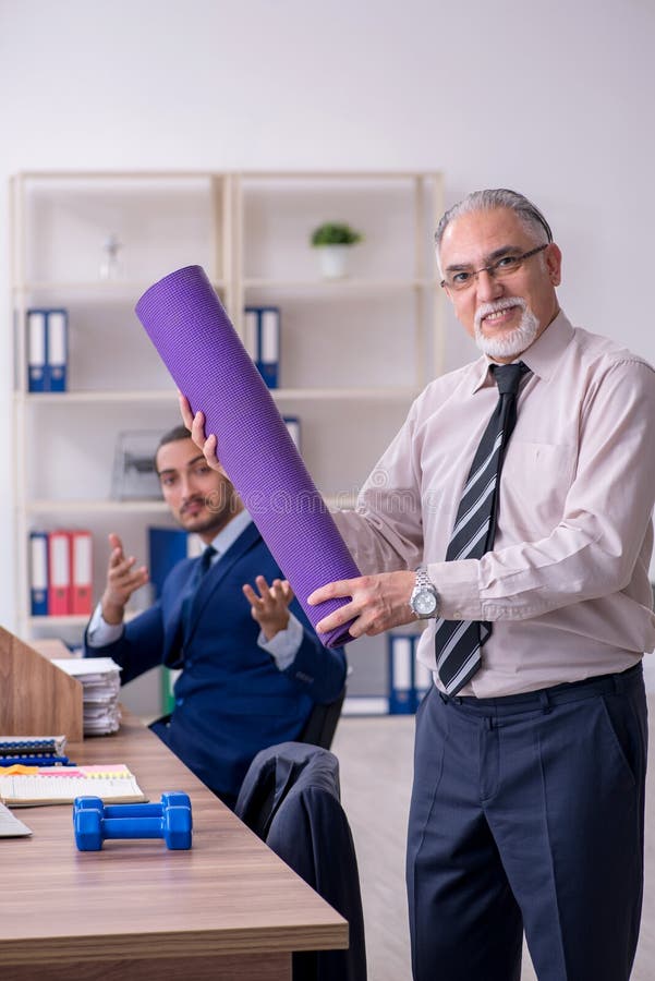 Two Employees Doing Physical Exercises at Workplace Stock Photo - Image ...