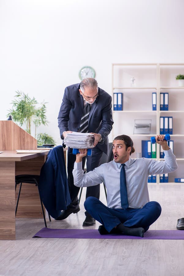 Two Employees Doing Physical Exercises at Workplace Stock Image - Image ...