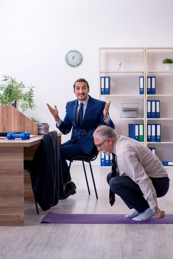 Two Employees Doing Physical Exercises at Workplace Stock Photo - Image ...