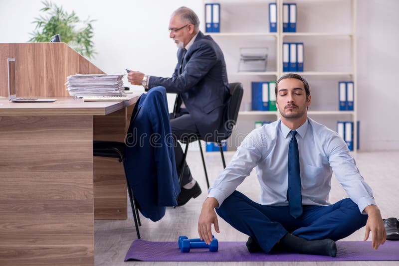 Two Employees Doing Physical Exercises at Workplace Stock Image - Image ...