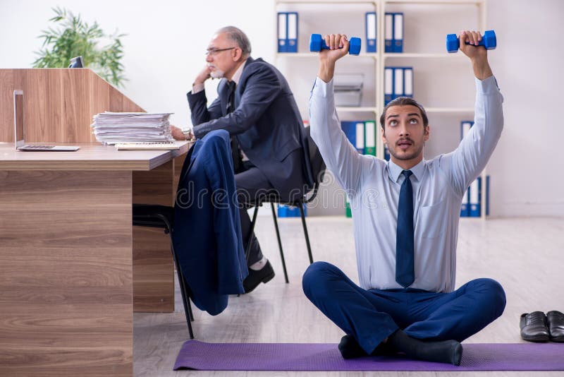 Two Employees Doing Physical Exercises at Workplace Stock Photo - Image ...