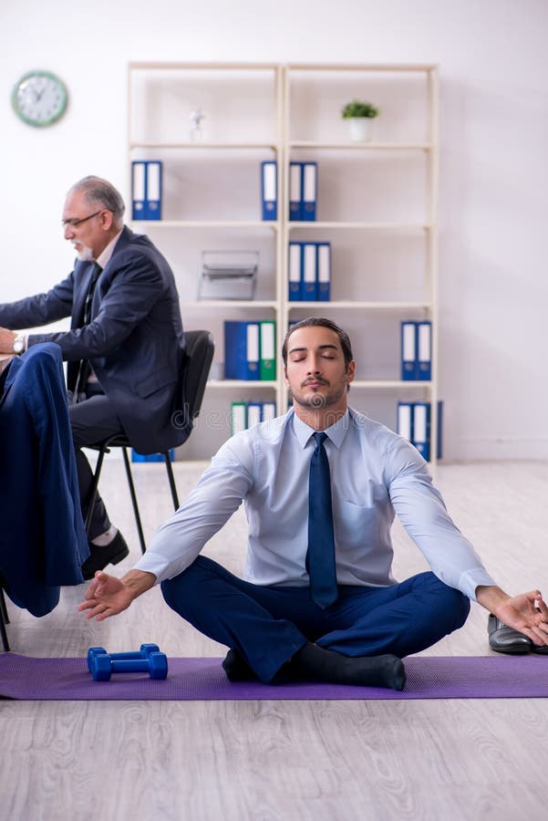 Two Employees Doing Physical Exercises at Workplace Stock Image - Image ...