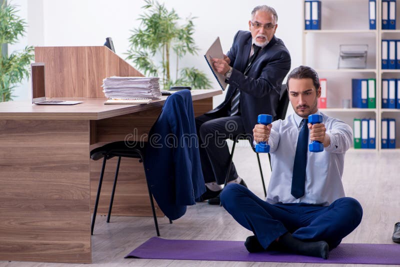 Two Employees Doing Physical Exercises at Workplace Stock Photo - Image ...