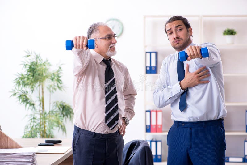 Two Employees Doing Physical Exercises at Workplace Stock Photo - Image ...