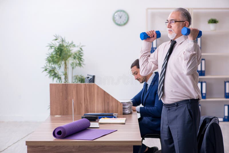 Two Employees Doing Physical Exercises at Workplace Stock Photo - Image ...