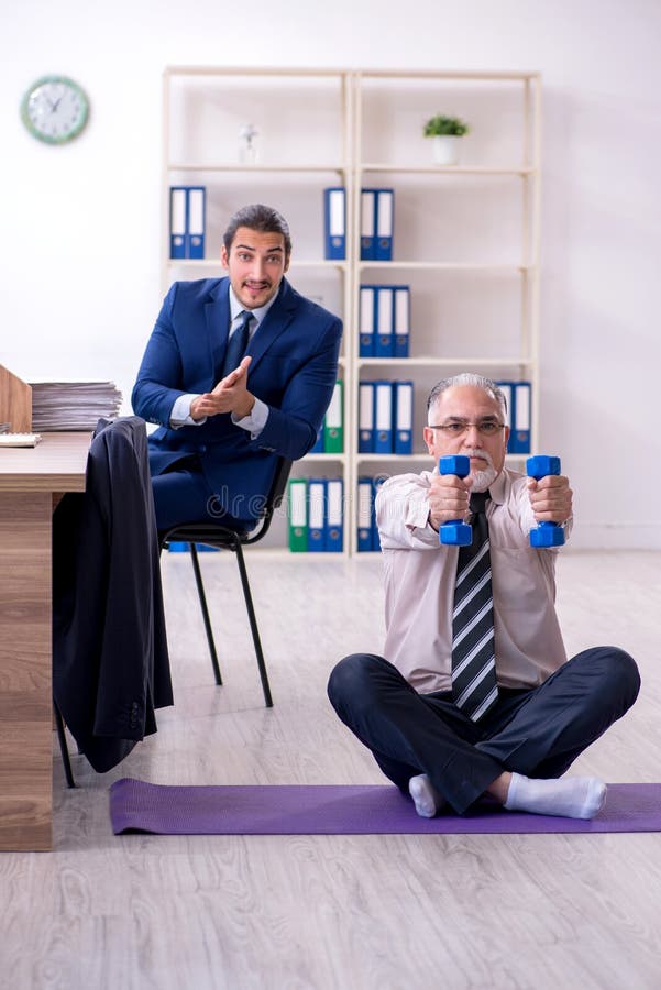 Two Employees Doing Physical Exercises at Workplace Stock Photo - Image ...