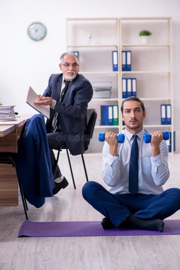 Two Employees Doing Physical Exercises at Workplace Stock Photo - Image ...