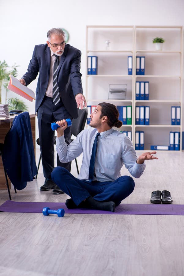 Two Employees Doing Physical Exercises at Workplace Stock Photo - Image ...