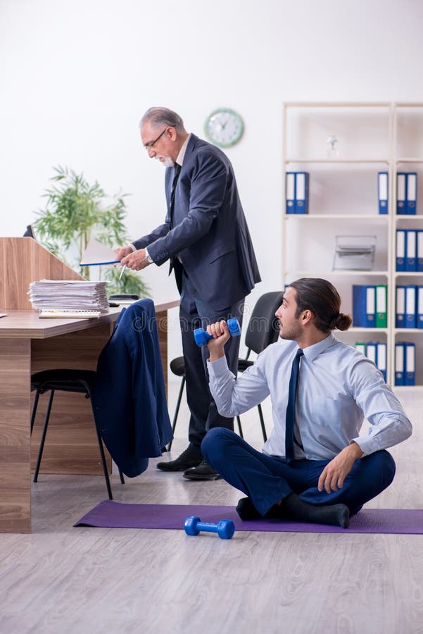 Two Employees Doing Physical Exercises at Workplace Stock Image - Image ...
