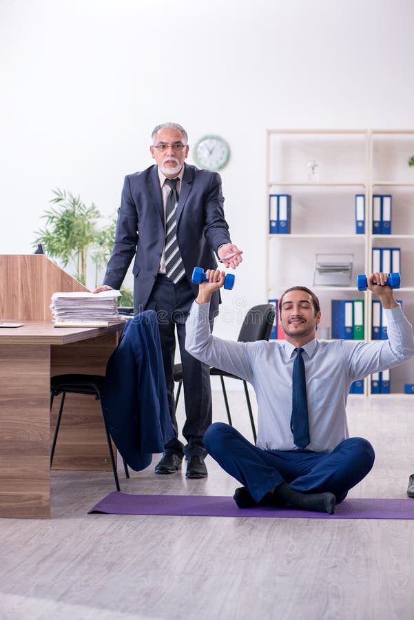 Two Employees Doing Physical Exercises at Workplace Stock Image - Image ...