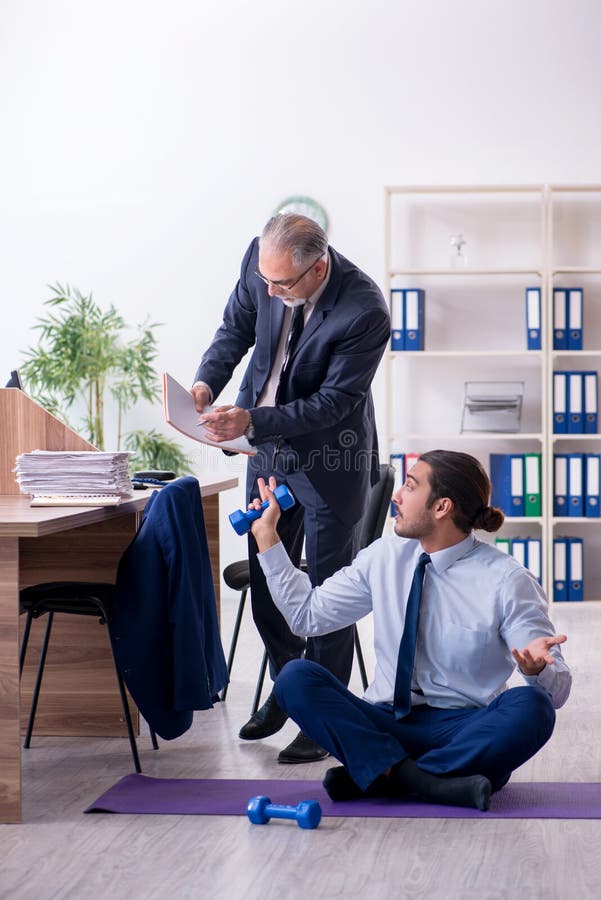 Two Employees Doing Physical Exercises at Workplace Stock Photo - Image ...