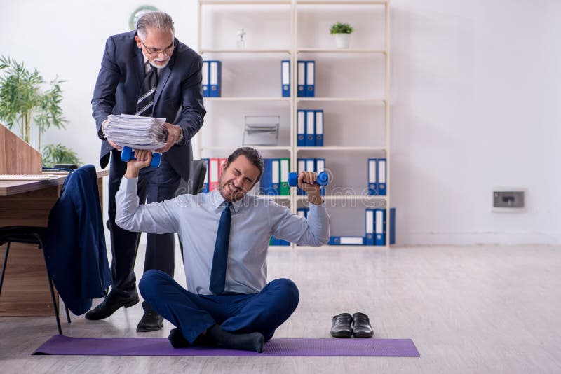 Two Employees Doing Physical Exercises at Workplace Stock Image - Image ...