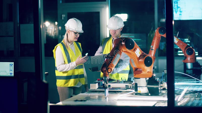 Robotics Engineers are Observing a Robotic Arm in Modern Lab Stock ...