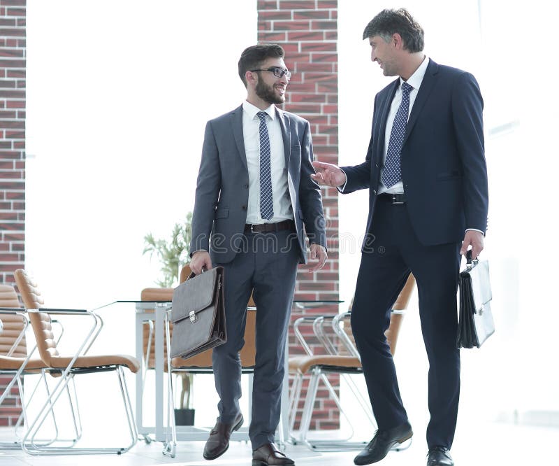 Two Businessmen Walking Along in Modern Office Building Stock Image ...