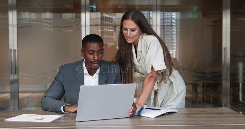 Two Employees Working on Joint Project in Office Using Laptop Stock ...