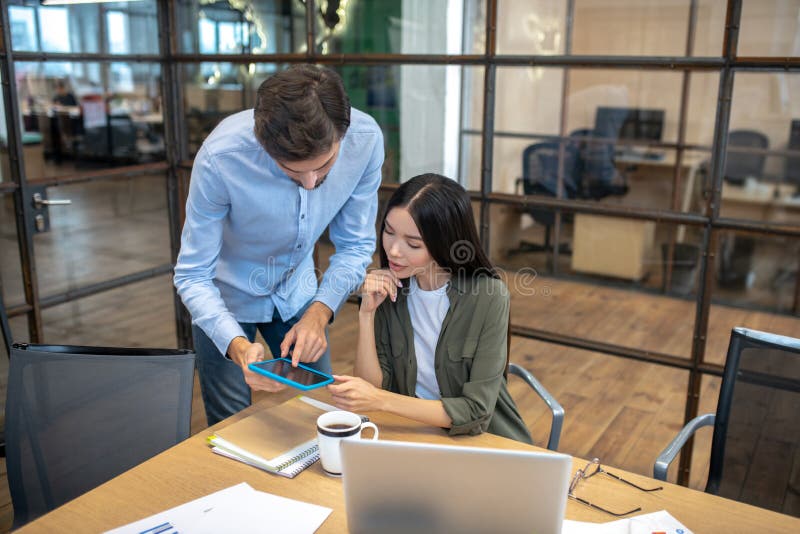 Two Employees Working in the Office and Looking Concentrated Stock ...