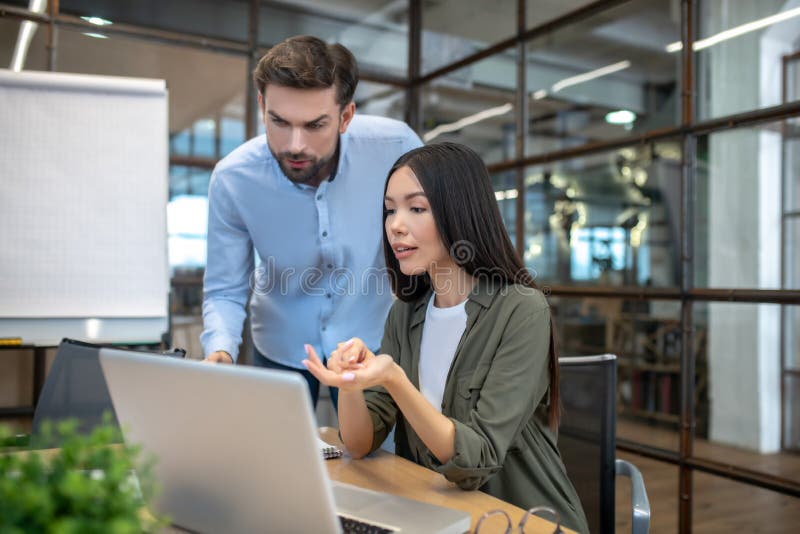 Two Employees Working in the Office and Looking Interested Stock Photo ...
