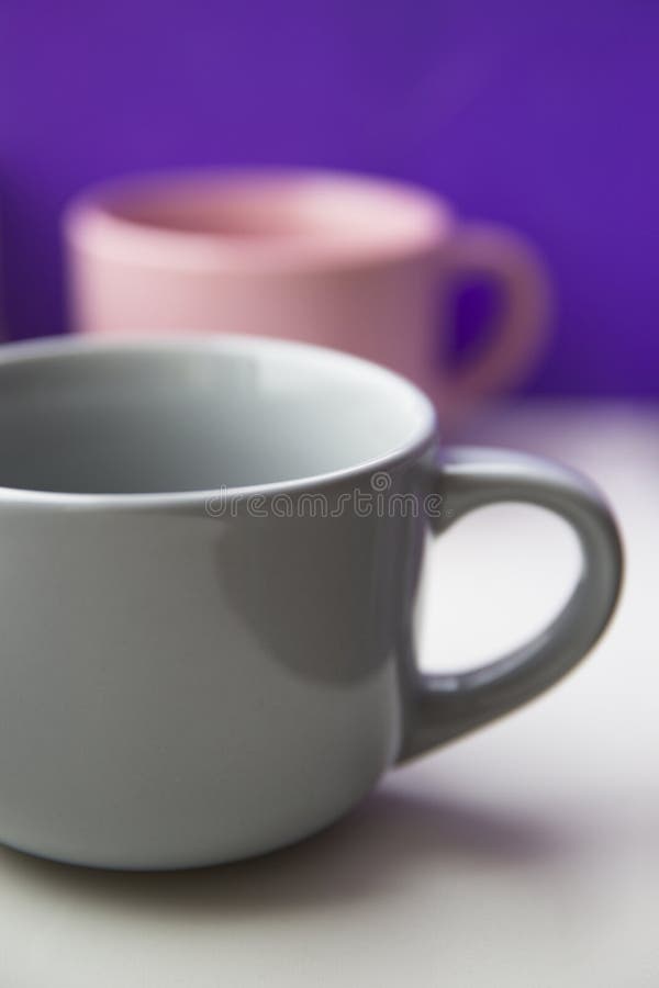 Two Empty Ceramic Mugs of Gray and Pink on the Table. Stock Image ...