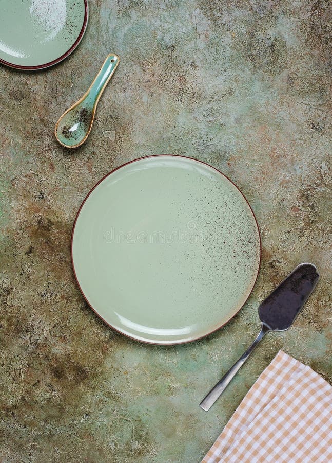 Two Empty Green Ceramic Plates, Ceramic Spoon, Spatula and Napkin on ...