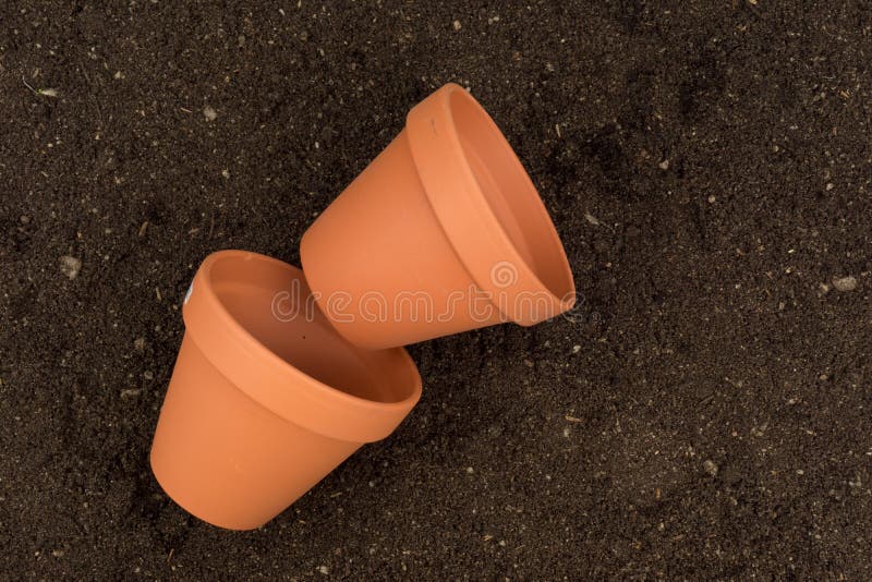 Two Empty Terracotta Growing Pot Lying on Dark Brown Soil Background ...