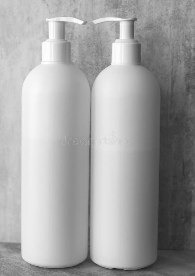 Two Empty White Plastic Containers with Dispenser on a Gray Background ...