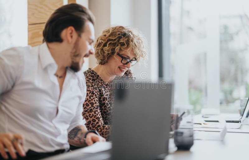 Two Engaged Businesspeople Working Together on a Project, Sharing Ideas ...