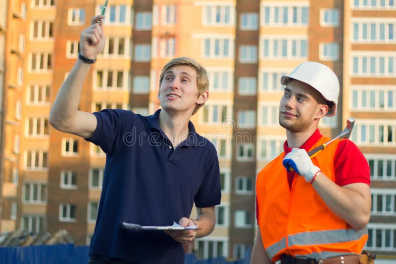 Two Engineer Builders with Blueprint Plan at Construction Site Stock ...