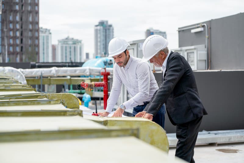 Two Engineer Discuss about Project on Building Plan or Drawing and Stay ...