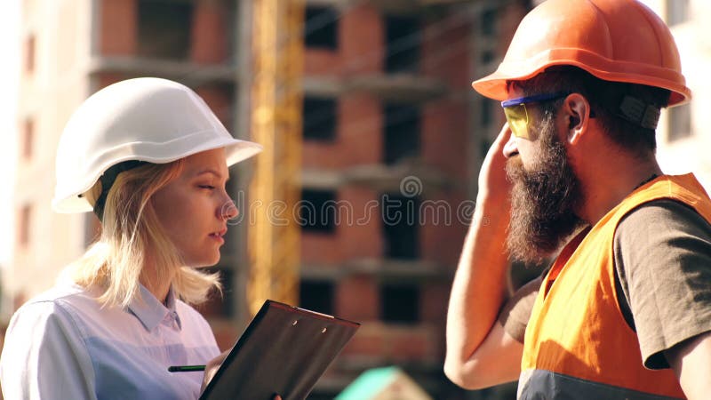 Two Engineer Have Consulting Meeting at Construction Site. Engineer on ...