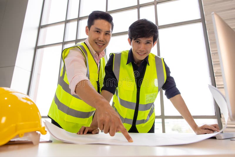 Two engineer reading plan stock image. Image of group - 177543823