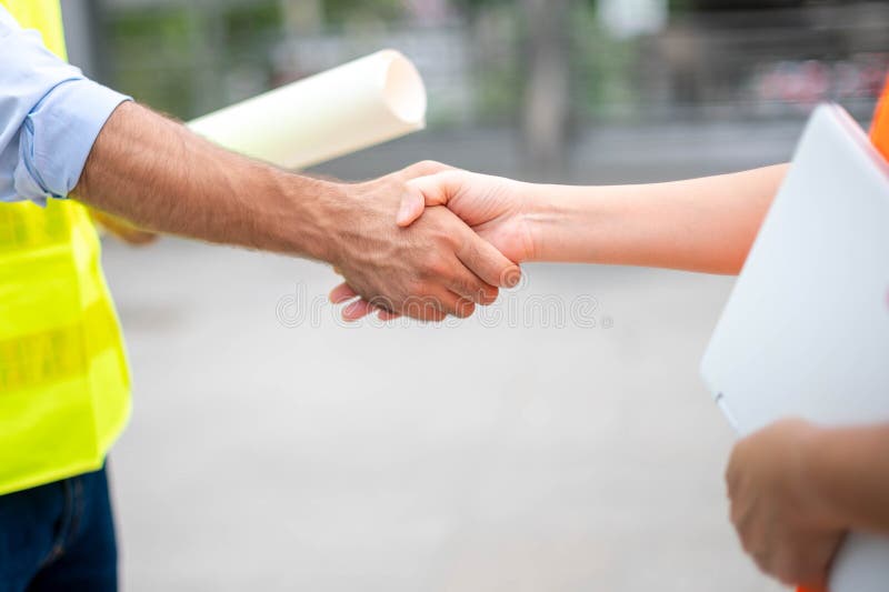 Two Engineer Shaking Hands with Deals and Success Agreement at ...