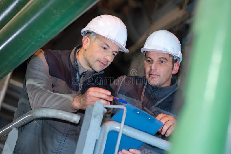Two Engineer Worker Working Together with Safety Uniform Stock Image ...