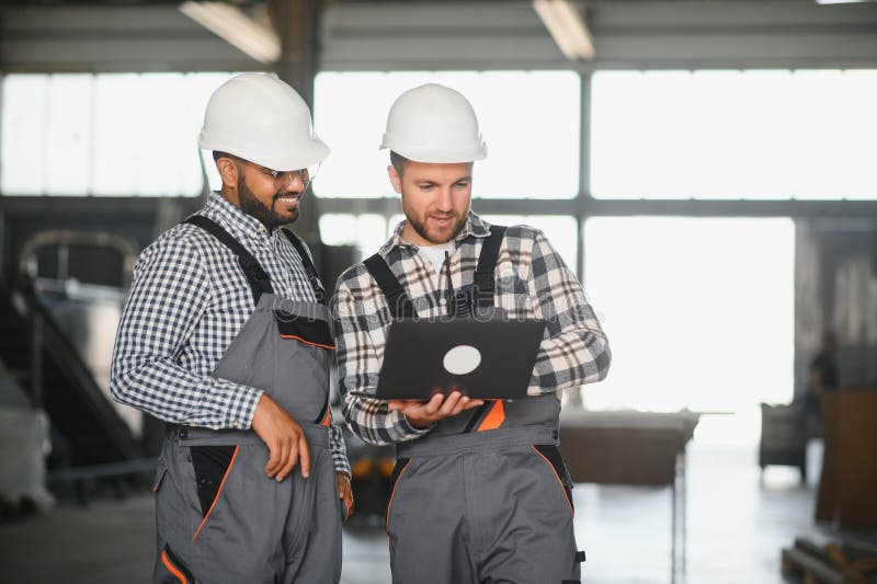 Two Engineer Worker Working Together with Safety Uniform and White ...