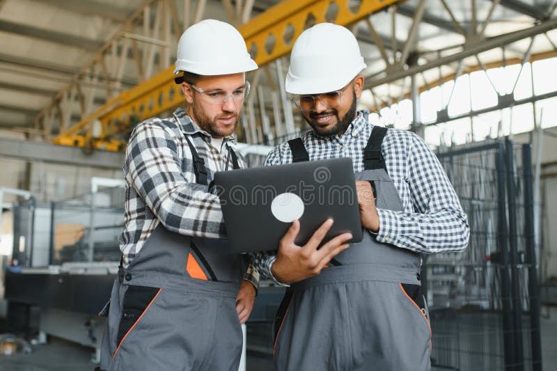 Two Engineer Worker Working Together with Safety Uniform and White ...