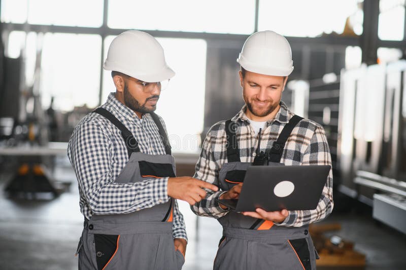 Two Engineer Worker Working Together with Safety Uniform and White ...