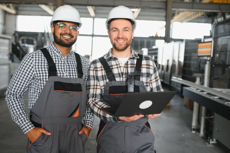 Two Engineer Worker Working Together with Safety Uniform and White ...