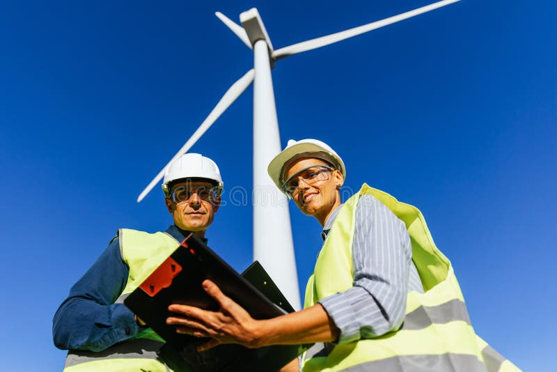 Two Engineer Workers Looking at Camera while Working in Wind Turbine ...