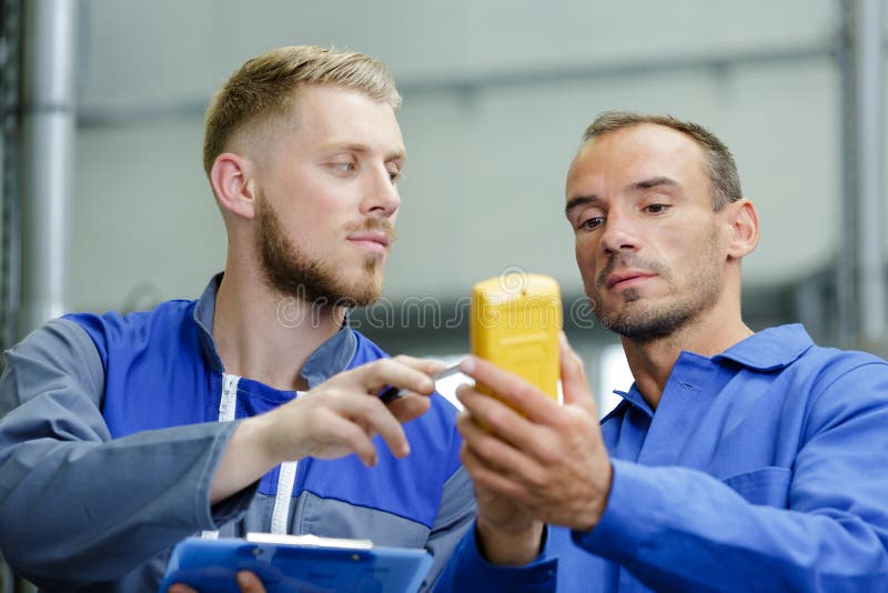 Two Engineer Working on Maintenance Equipment Stock Photo - Image of ...