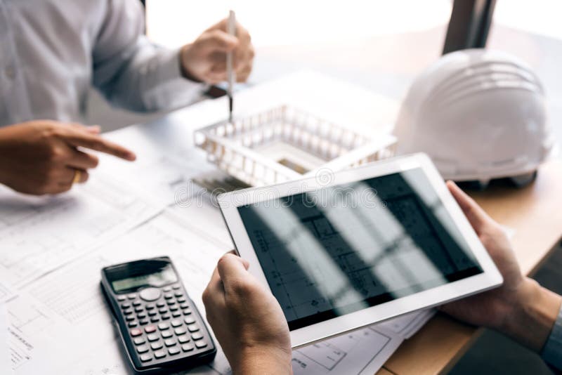 Two Engineering Working Together and Using Digital Tablet Looking ...