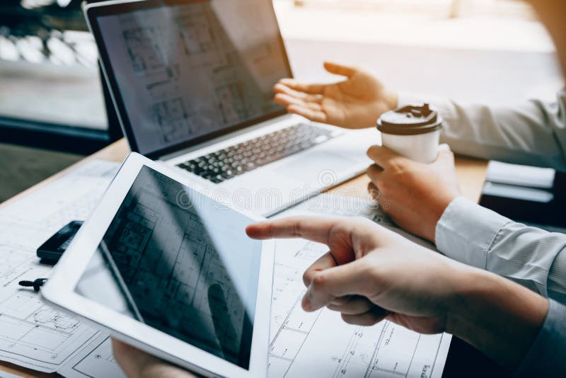 Two Engineering Working Together and Using Digital Tablet Looking ...