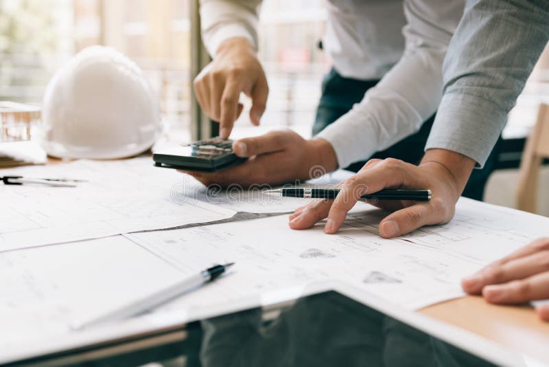 Two Engineering Working Together and Using Digital Tablet Looking ...