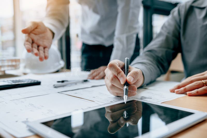 Two Engineering Working Together and Using Digital Tablet Looking ...