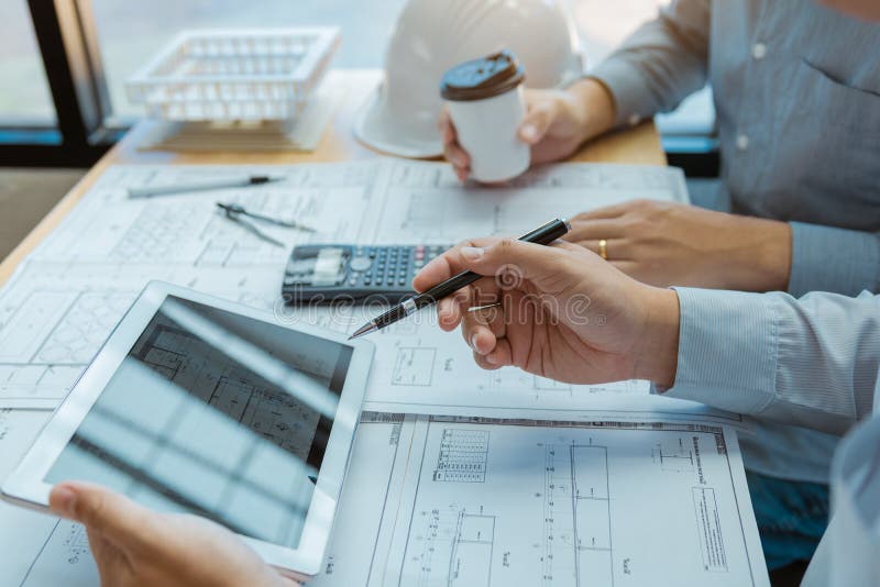 Two Engineering Working Together and Using Digital Tablet Looking ...