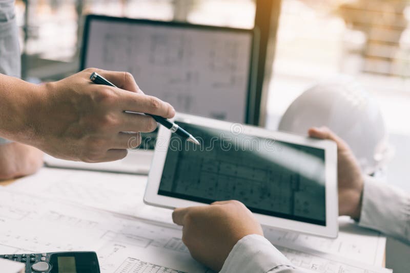 Two Engineering Working Together and Using Digital Tablet Looking ...