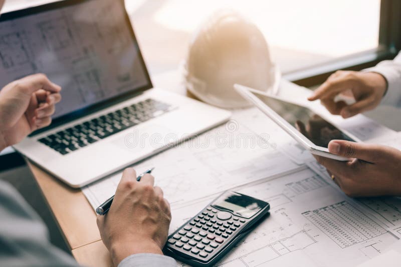 Two Engineering Working Together and Using Digital Tablet Looking ...