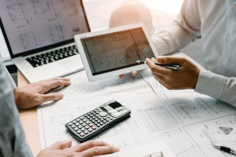 Two Engineering Working Together and Using Digital Tablet Looking ...