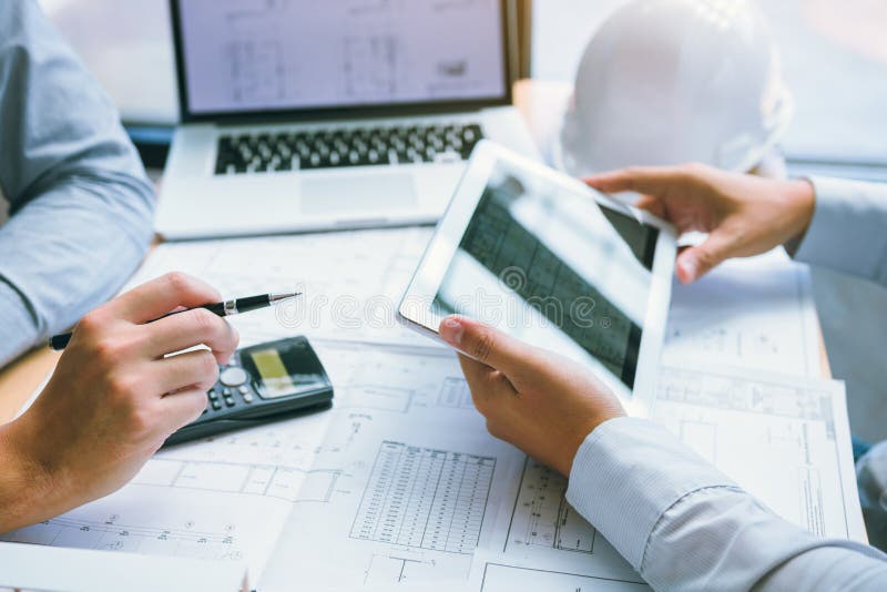 Two Engineering Working Together and Using Digital Tablet Looking ...