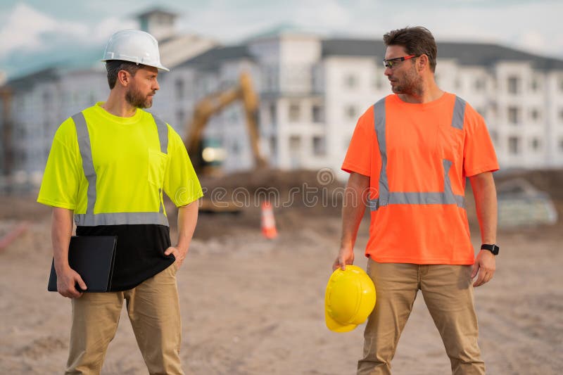 Two Engineers. Architect at a Construction Site. Handyman Builders in ...